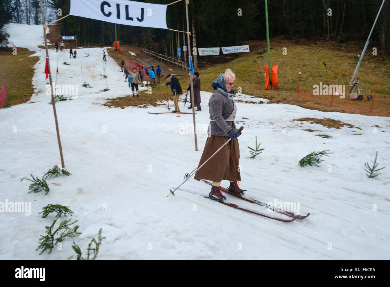 Skiers in traditional retro style costumes, with old wooden ski gear at ...