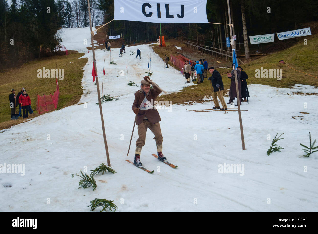 Skiers in traditional retro style costumes, with old wooden ski gear at ...