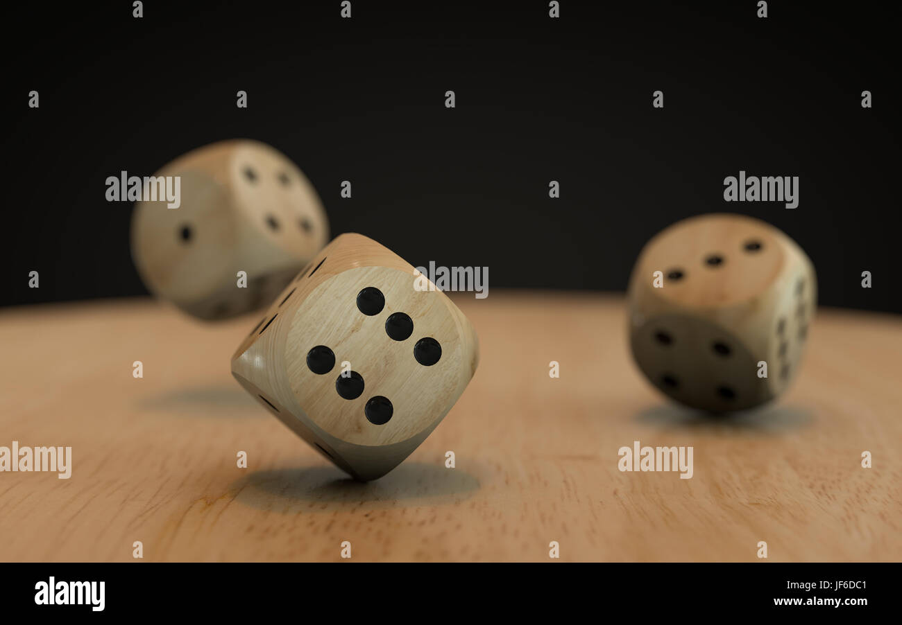 Rolling down three dice on a wooden desk with a black background Stock ...