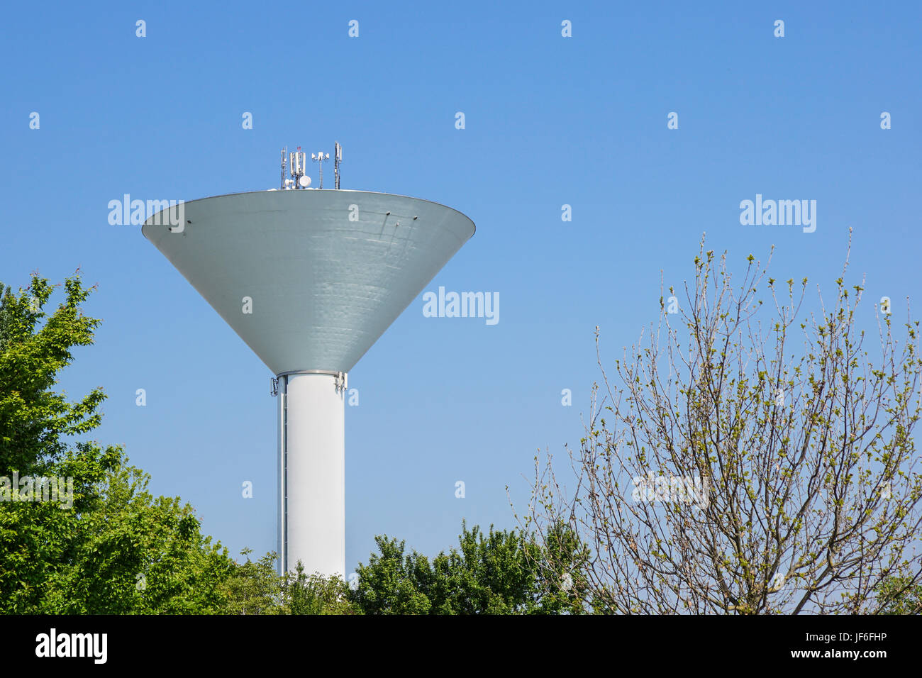 concrete modern water tower against blue sky Stock Photo - Alamy