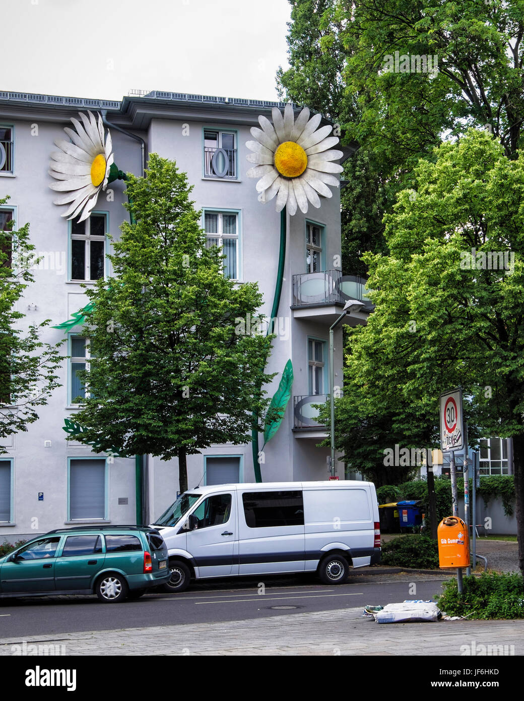 Giant daisy flowers decorate exterior facade of apartment building ...