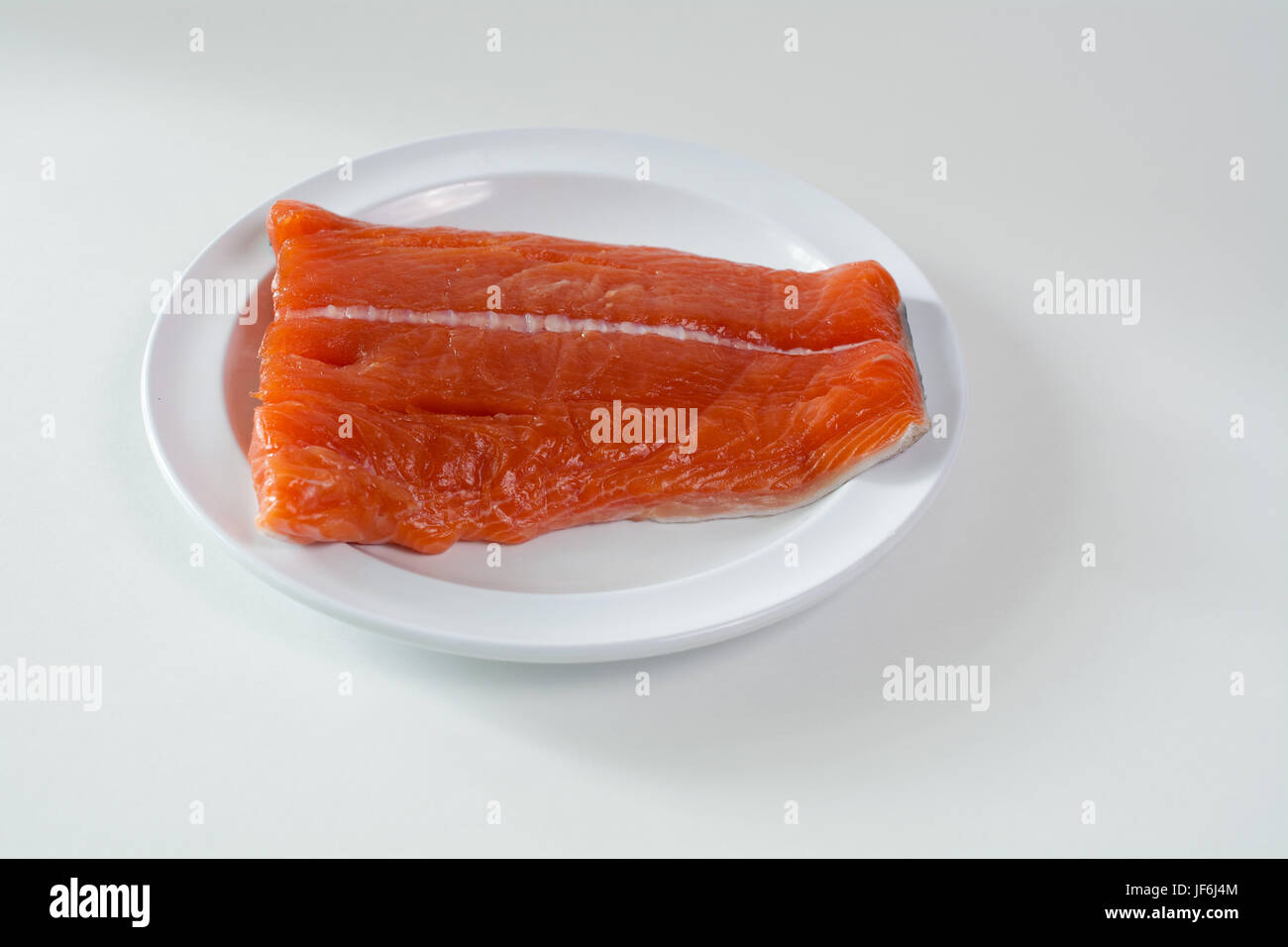 Side top view of raw wild king Salmon Fillet lying on white place ...
