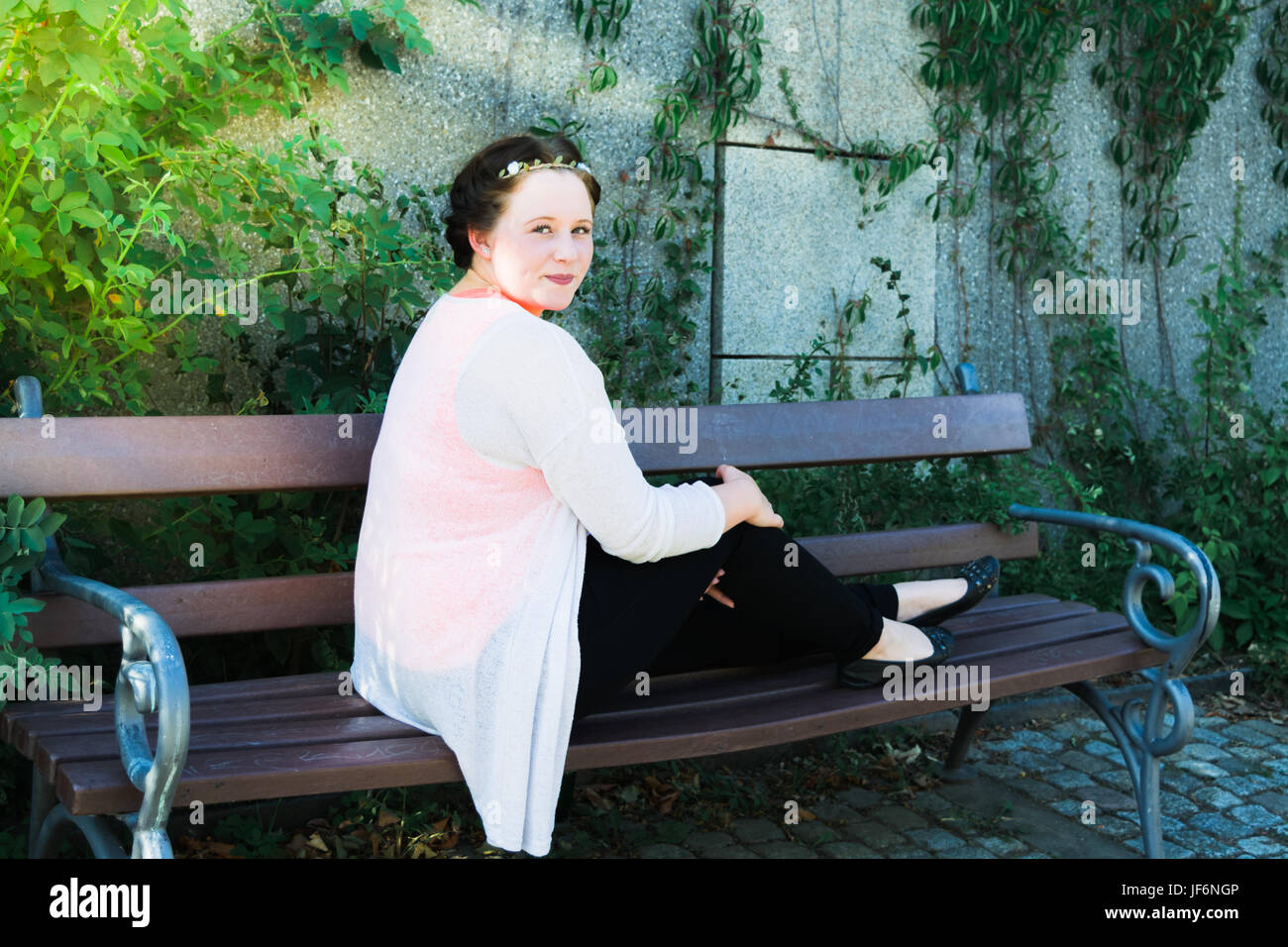 Woman relaxing on a bench hi-res stock photography and images - Alamy