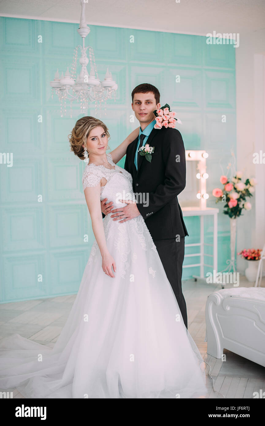 Happy couple. Wedding photo shoot in the white studio with wedding ...
