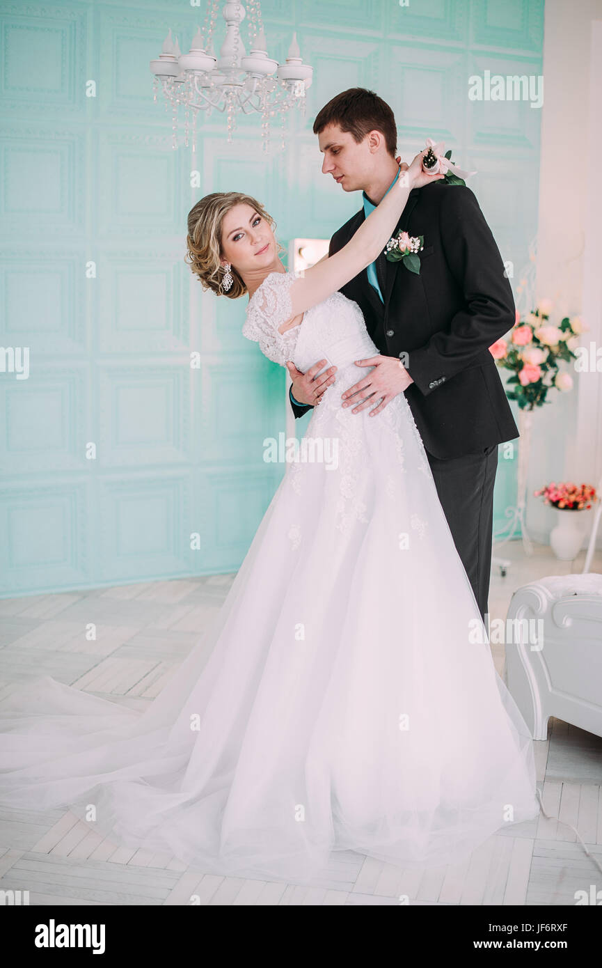 Happy couple. Wedding photo shoot in the white studio with wedding ...