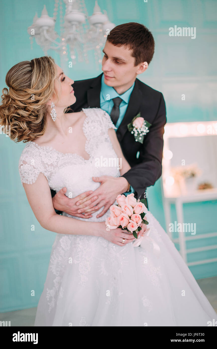 Happy couple. Wedding photo shoot in the white studio with wedding ...