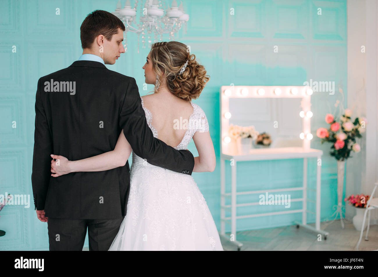 Happy couple. Wedding photo shoot in the white studio with wedding ...