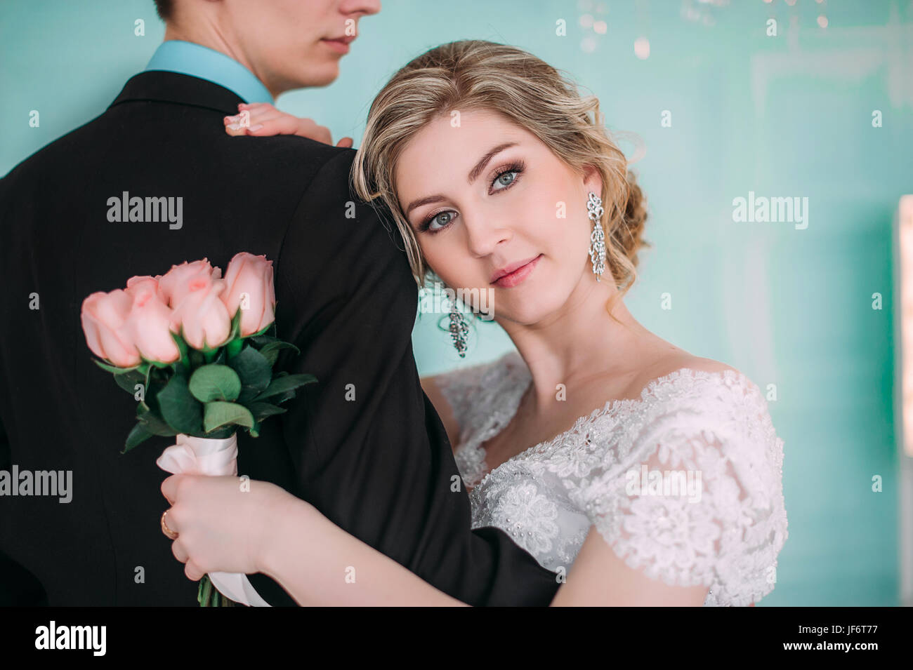 Happy couple. Wedding photo shoot in the white studio with wedding ...