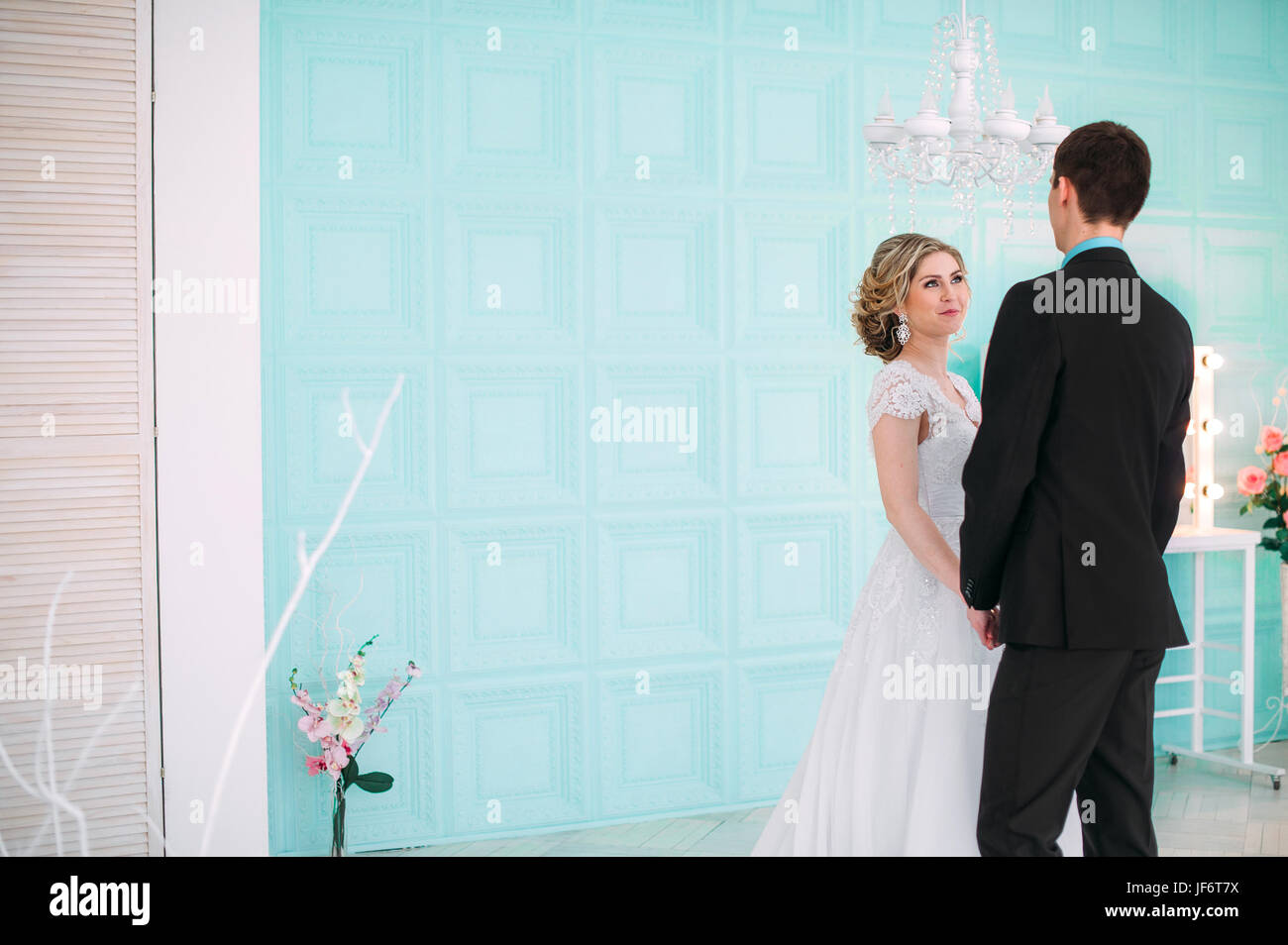 Happy couple. Wedding photo shoot in the white studio with wedding ...