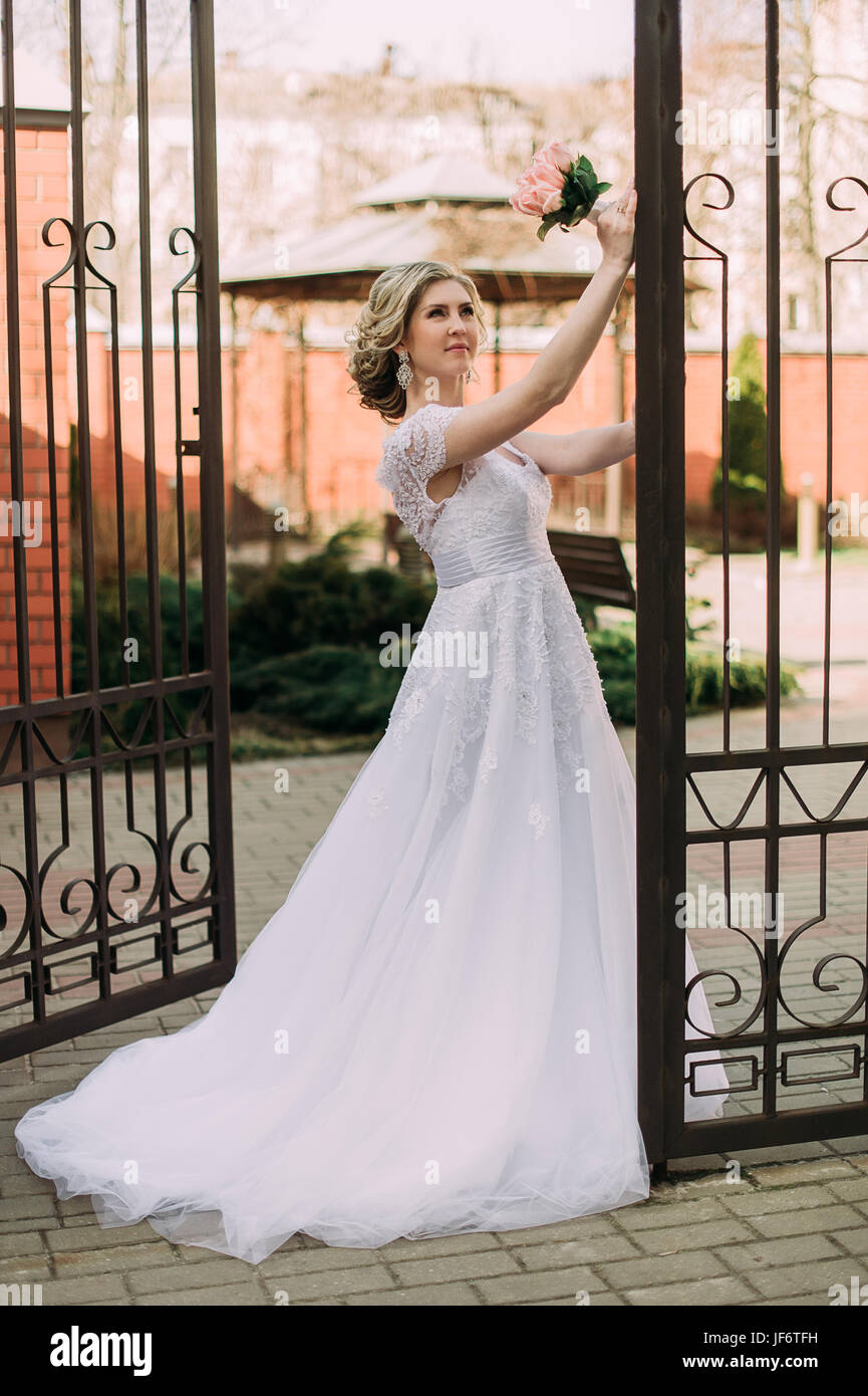 Beautiful bride woman portrait with bridal bouquet posing in her ...