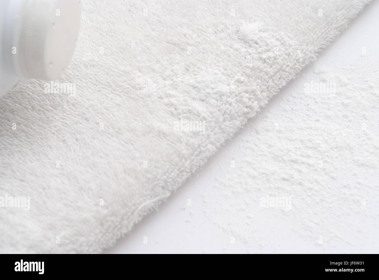 talcum powder on a soft white towel background Stock Photo - Alamy