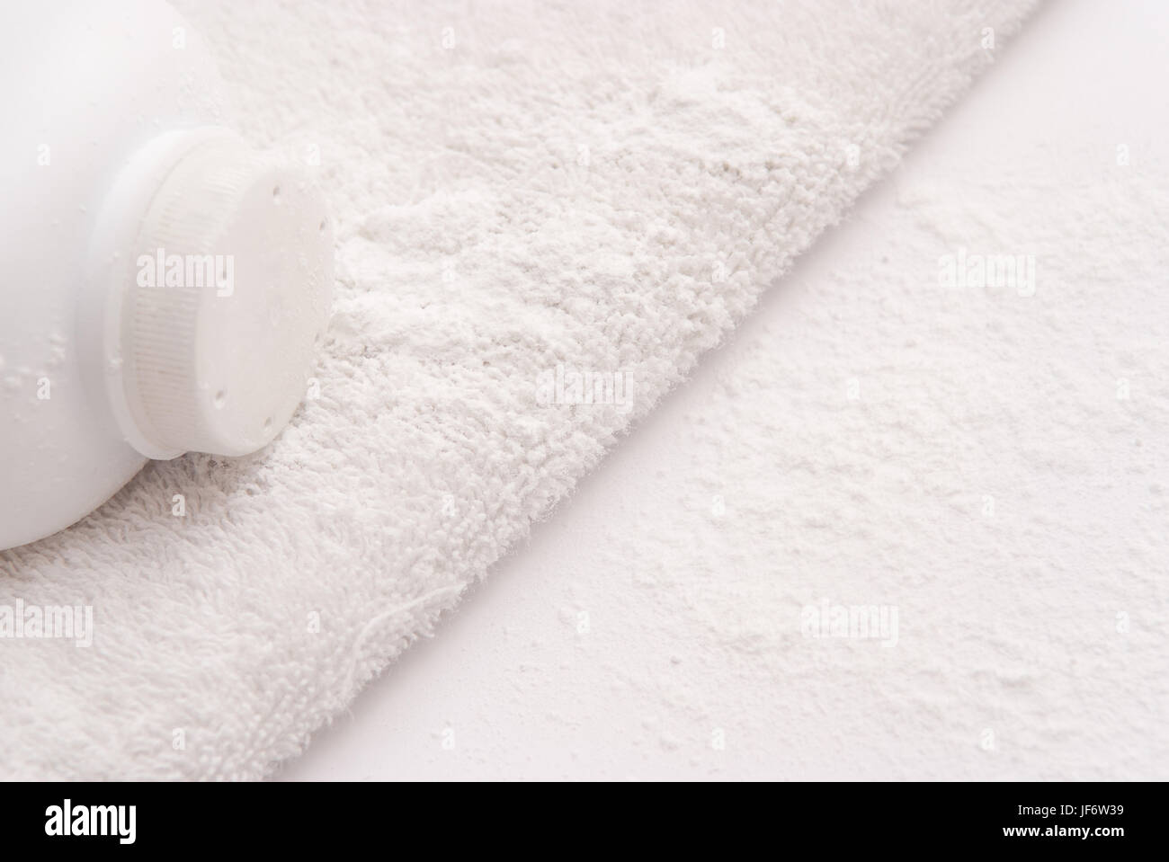 talcum powder on a soft white towel background Stock Photo - Alamy