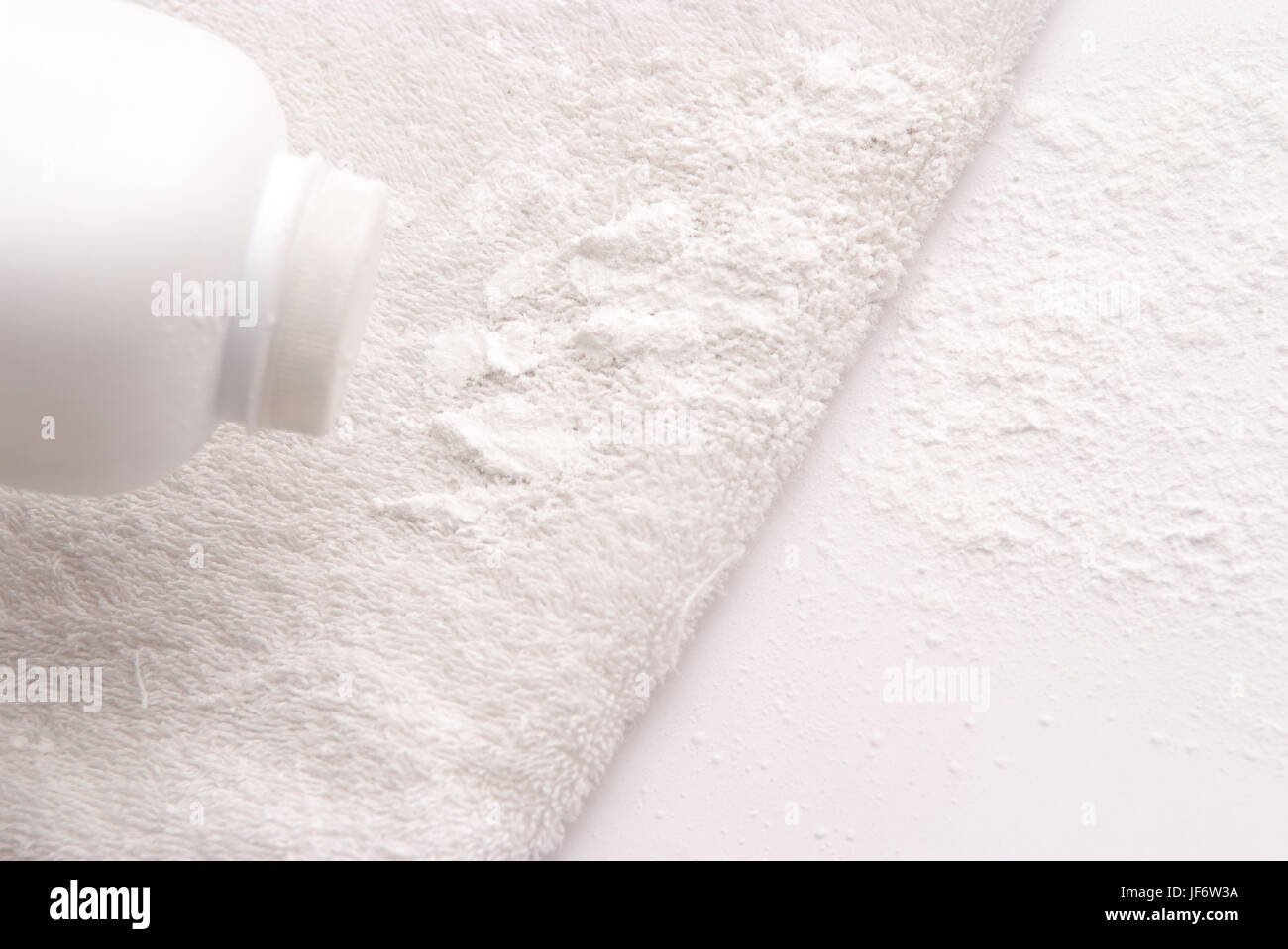 talcum powder on a soft white towel background Stock Photo - Alamy