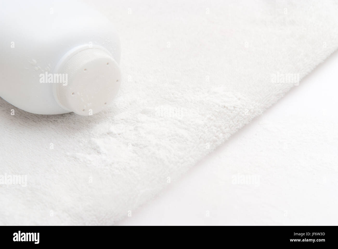 talcum powder on a soft white towel background Stock Photo - Alamy