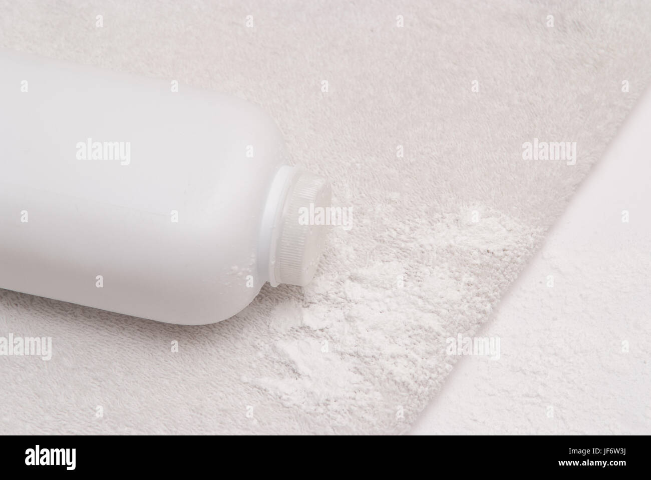 talcum powder on a soft white towel background Stock Photo - Alamy