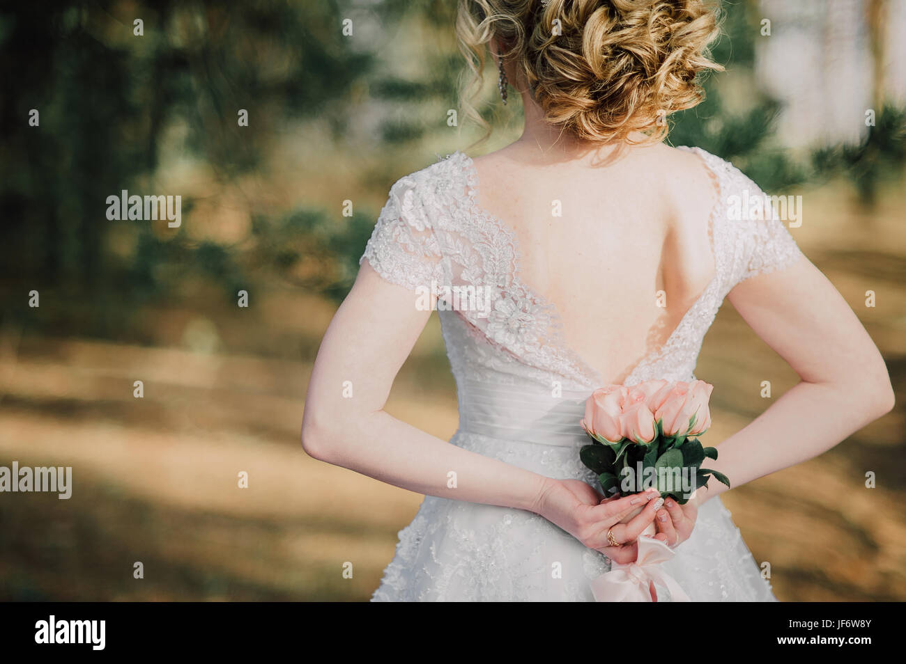Back view girl holding bunch of flowers hi-res stock photography and ...