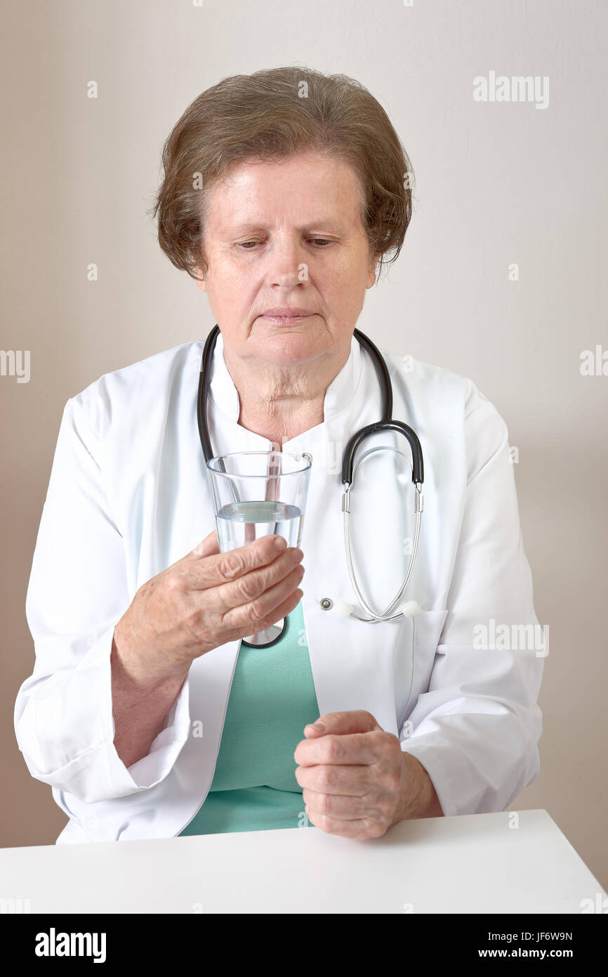 Female doctor holding glass water hi-res stock photography and images ...