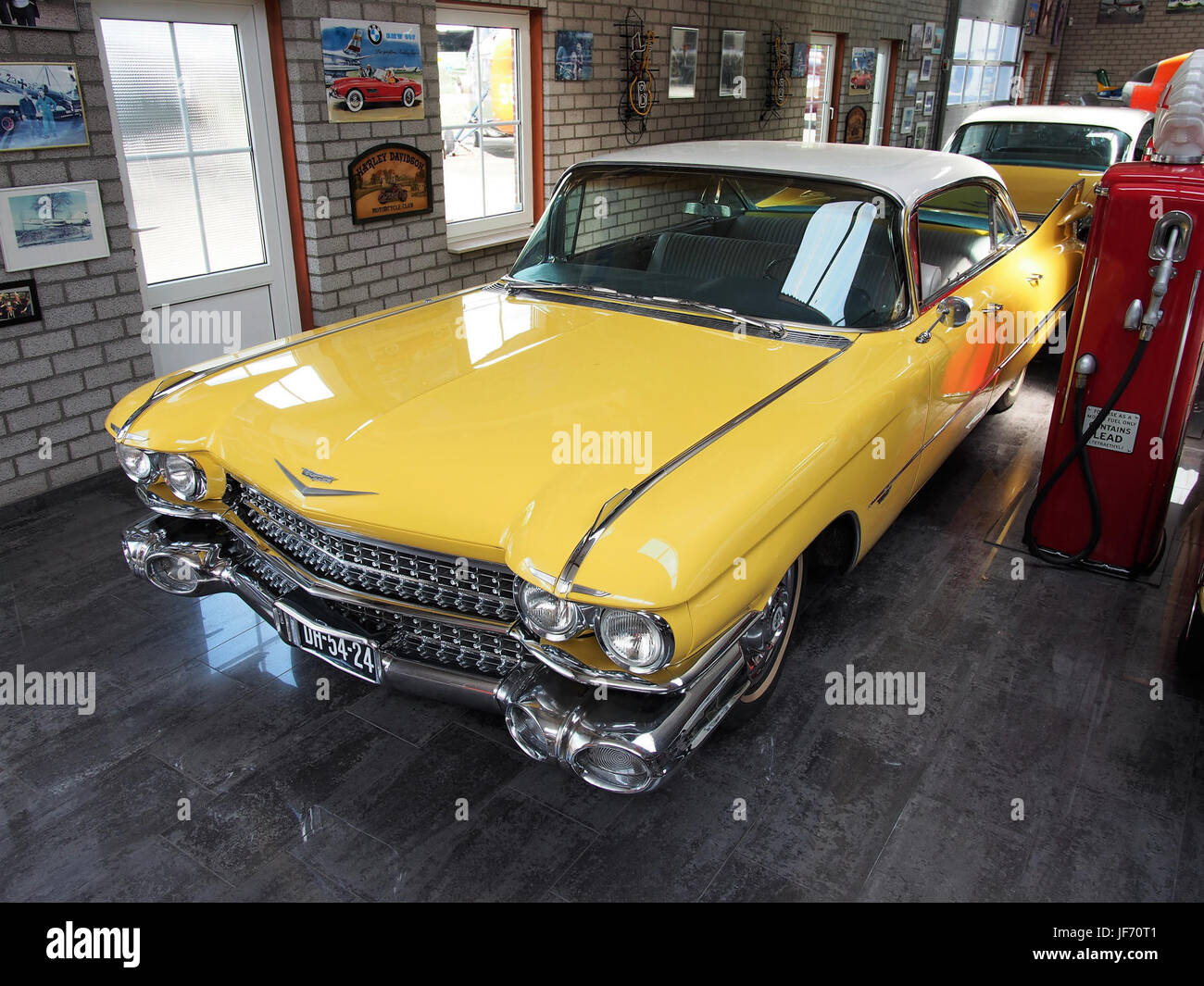A classic yellow Cadillac, known for its iconic American luxury and ...
