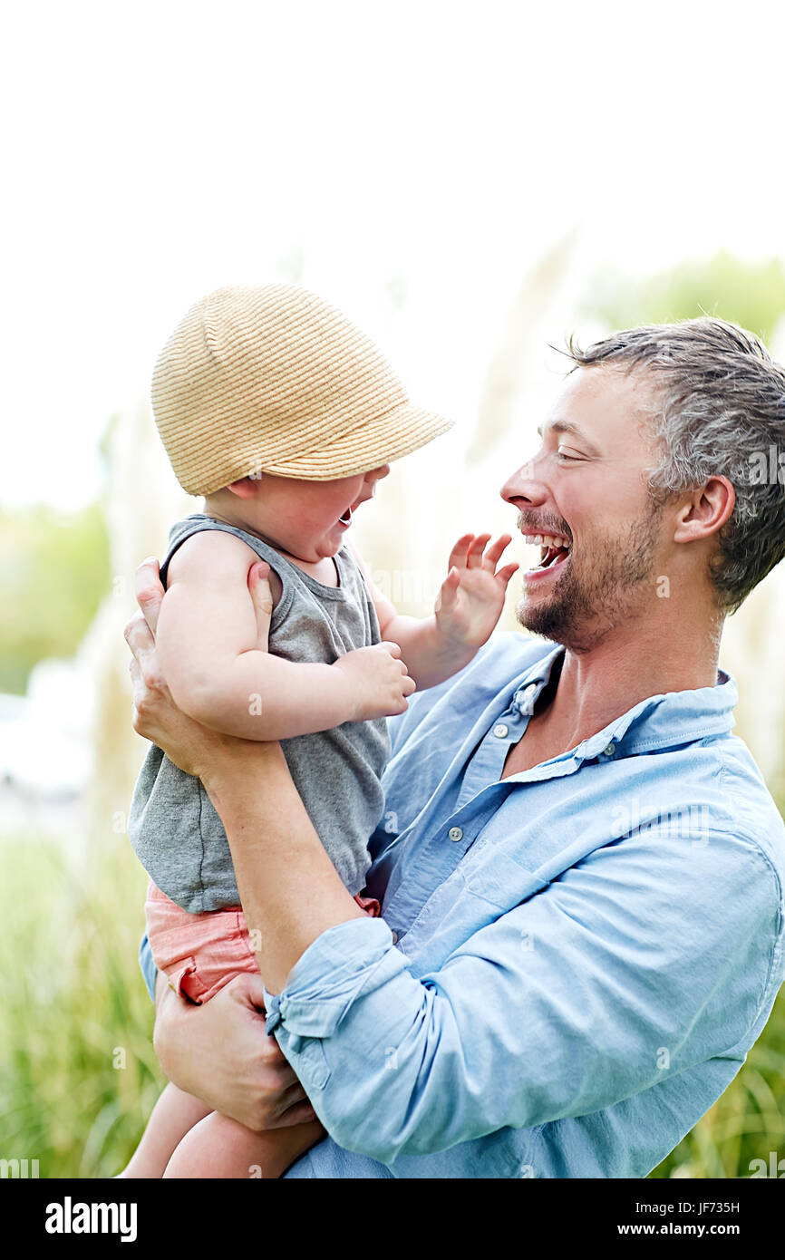 Father laughing with baby son Stock Photo - Alamy