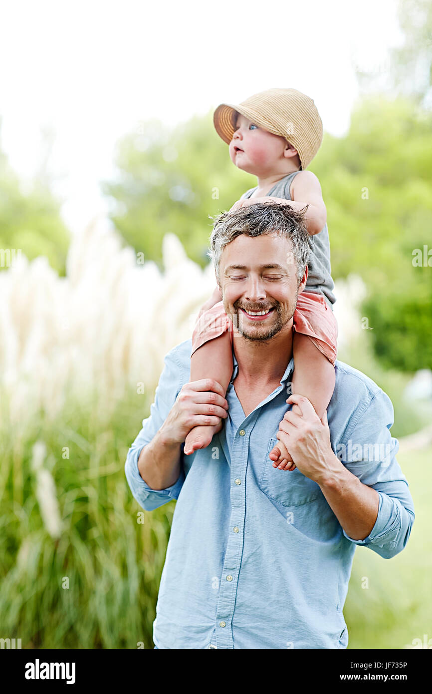 Father carrying baby son on shoulders Stock Photo - Alamy