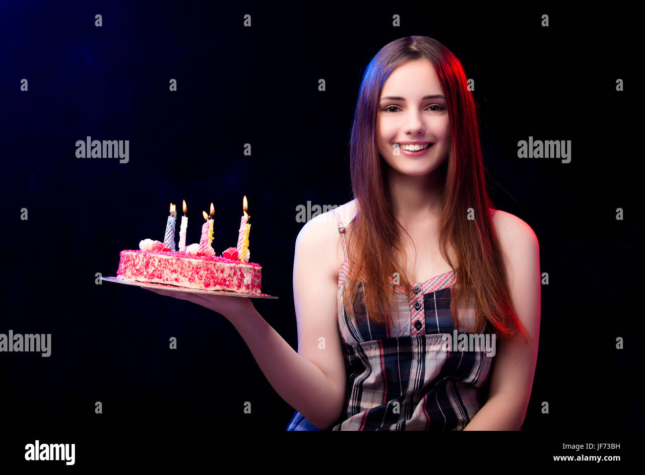 Young woman with birthday cake at party Stock Photo - Alamy