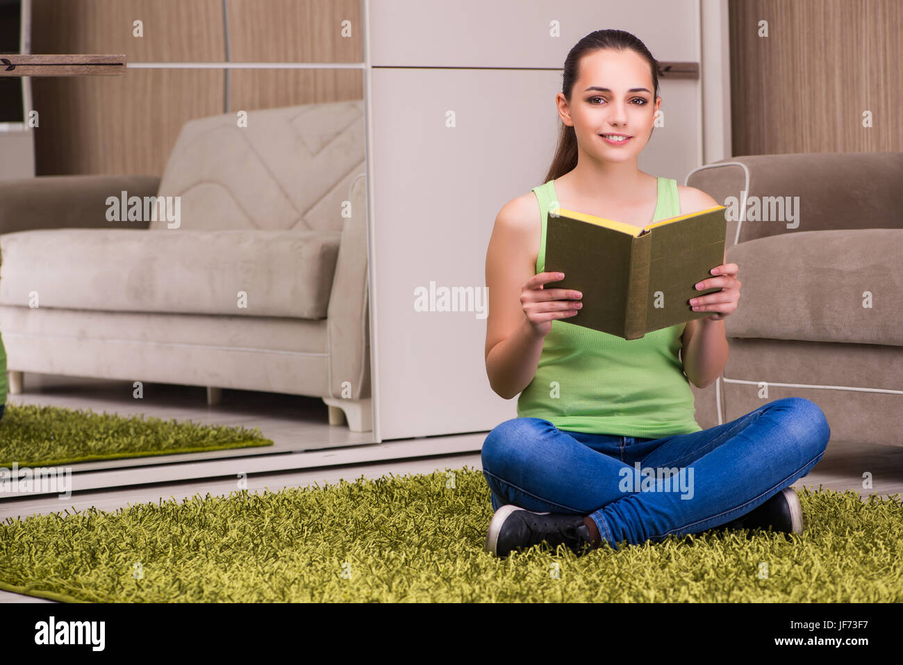 Young woman reading books at home Stock Photo - Alamy