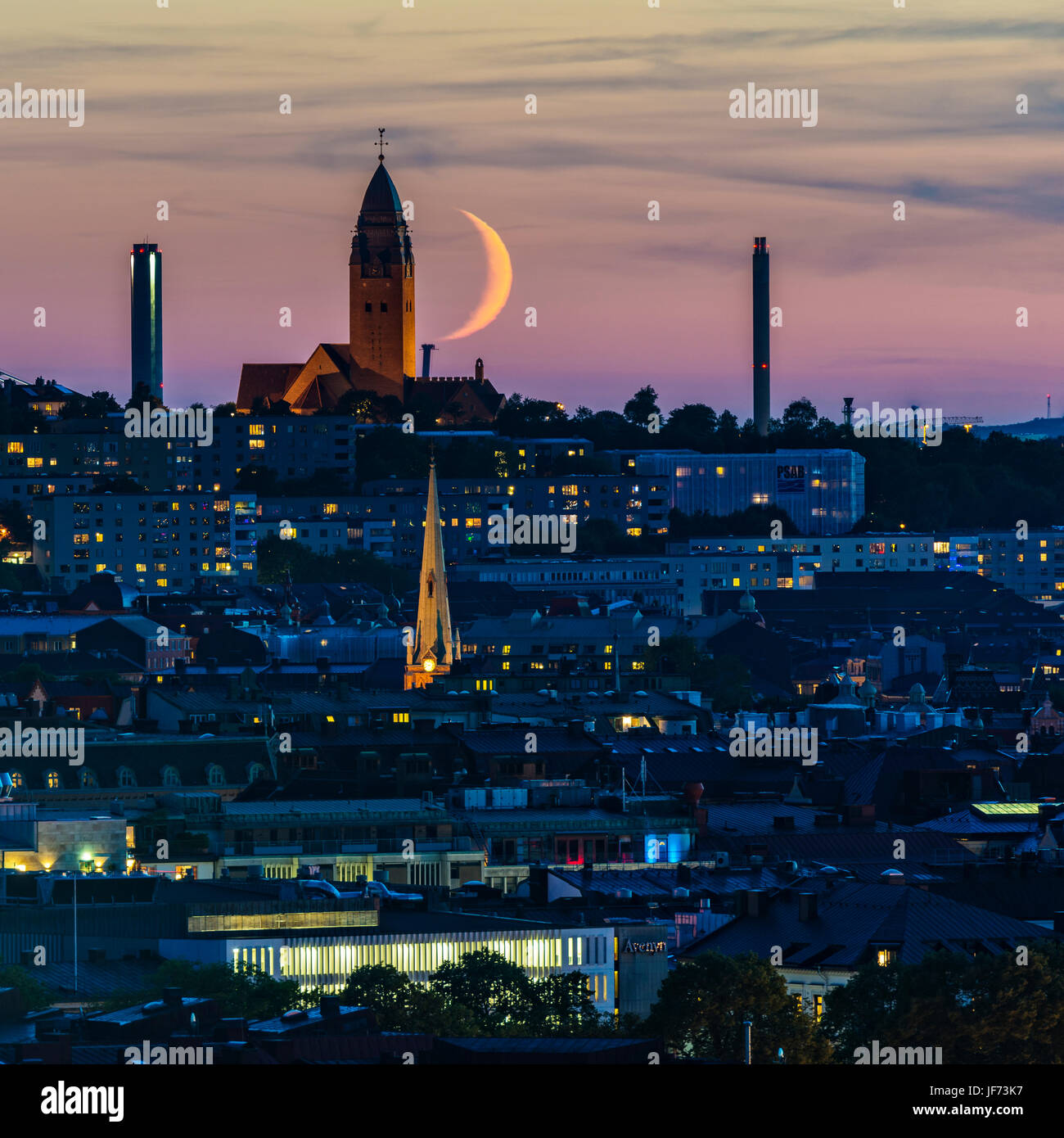 Crescent moon above city at dusk Stock Photo - Alamy