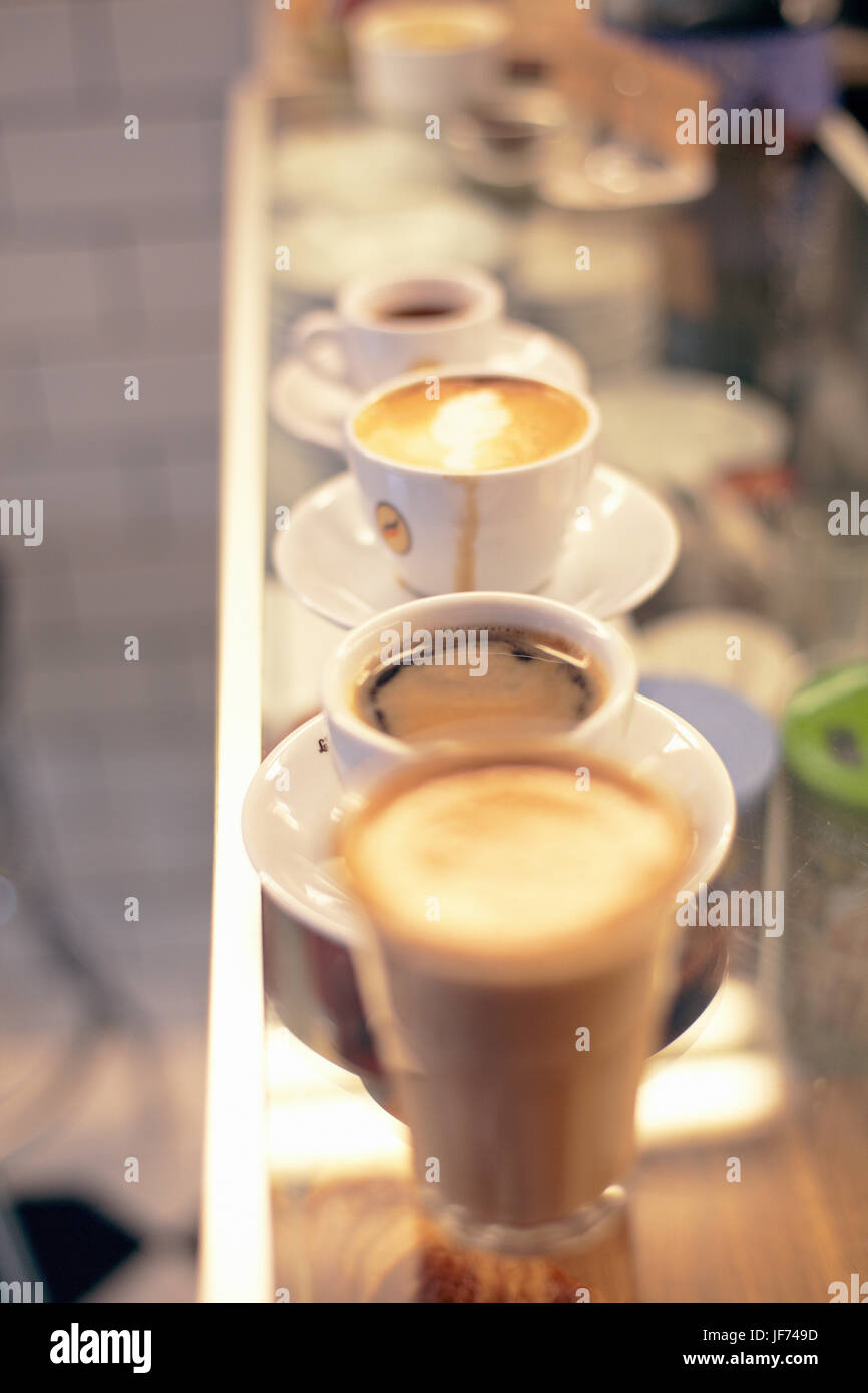 Coffee cups in row on bar counter Stock Photo - Alamy