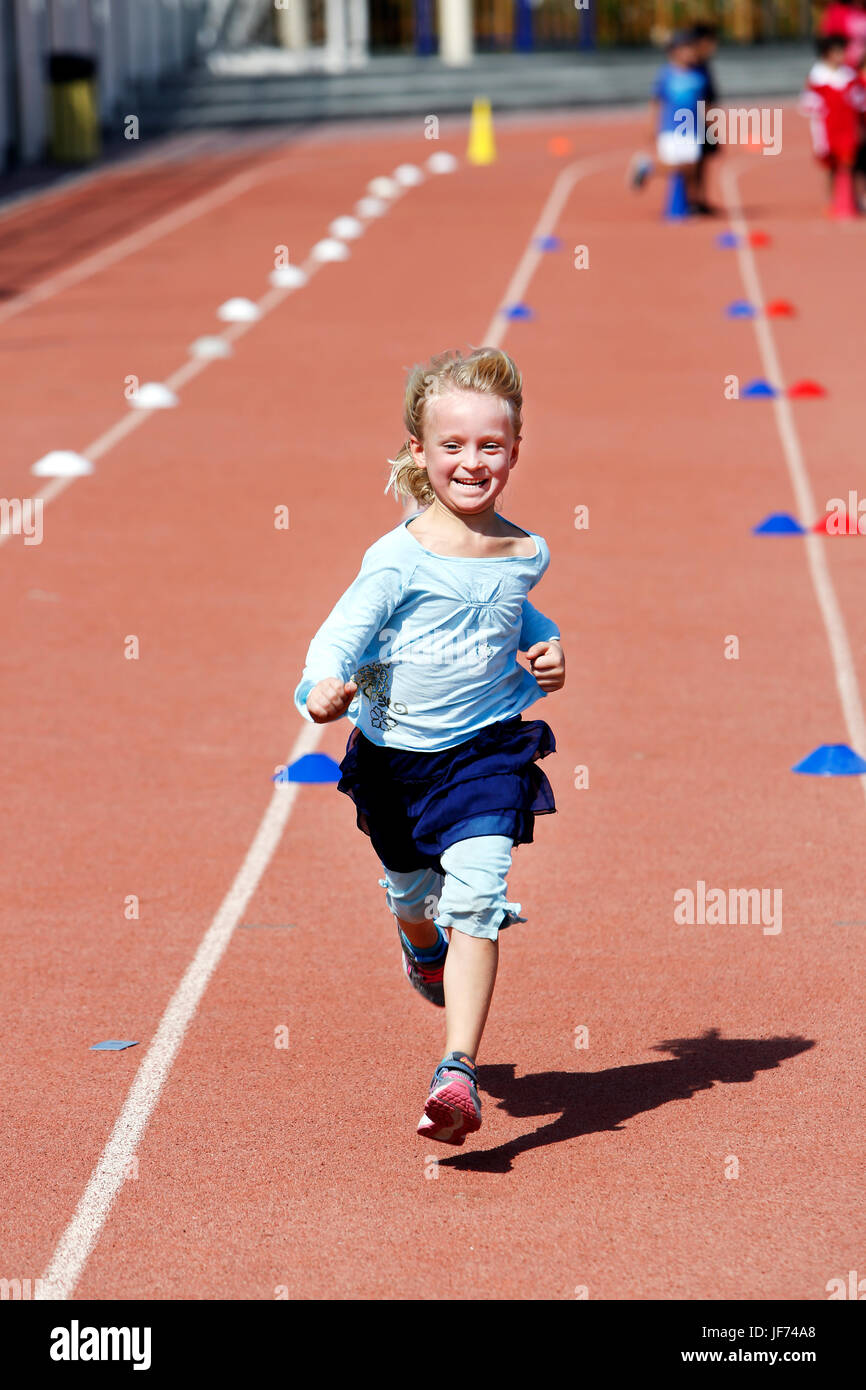 Girl running on track Stock Photo - Alamy