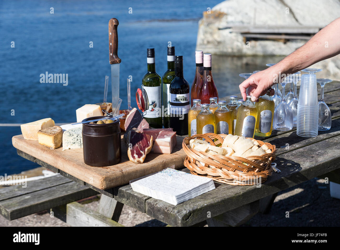Man taking bottle from table Stock Photo - Alamy