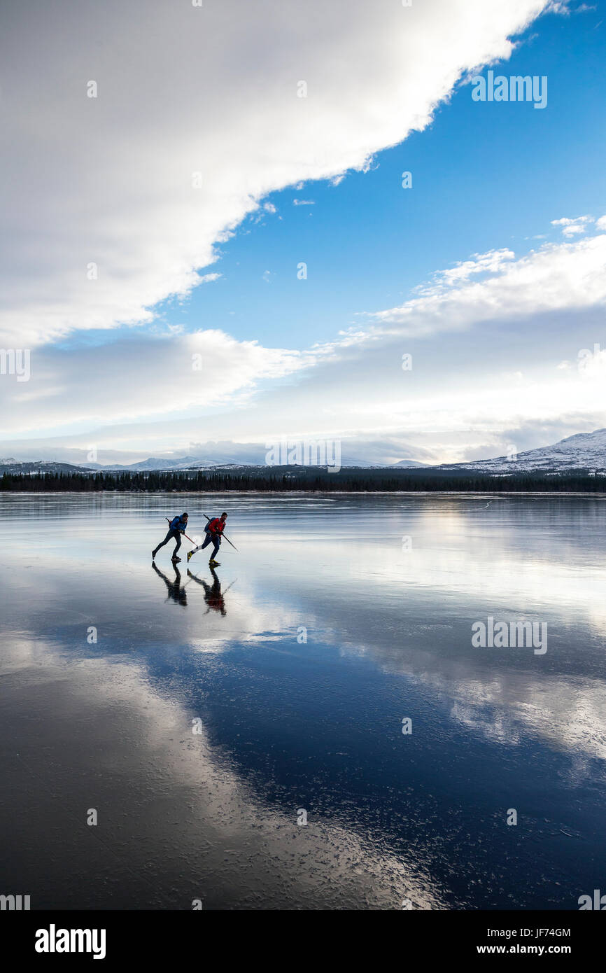 Two people moving on ice Stock Photo - Alamy