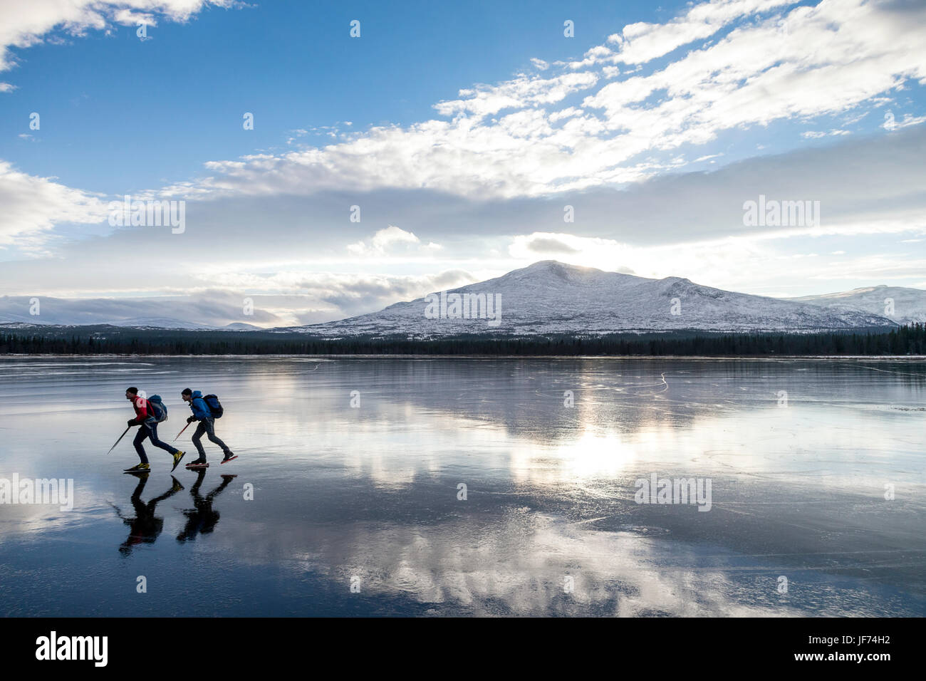 Two people moving on ice Stock Photo - Alamy