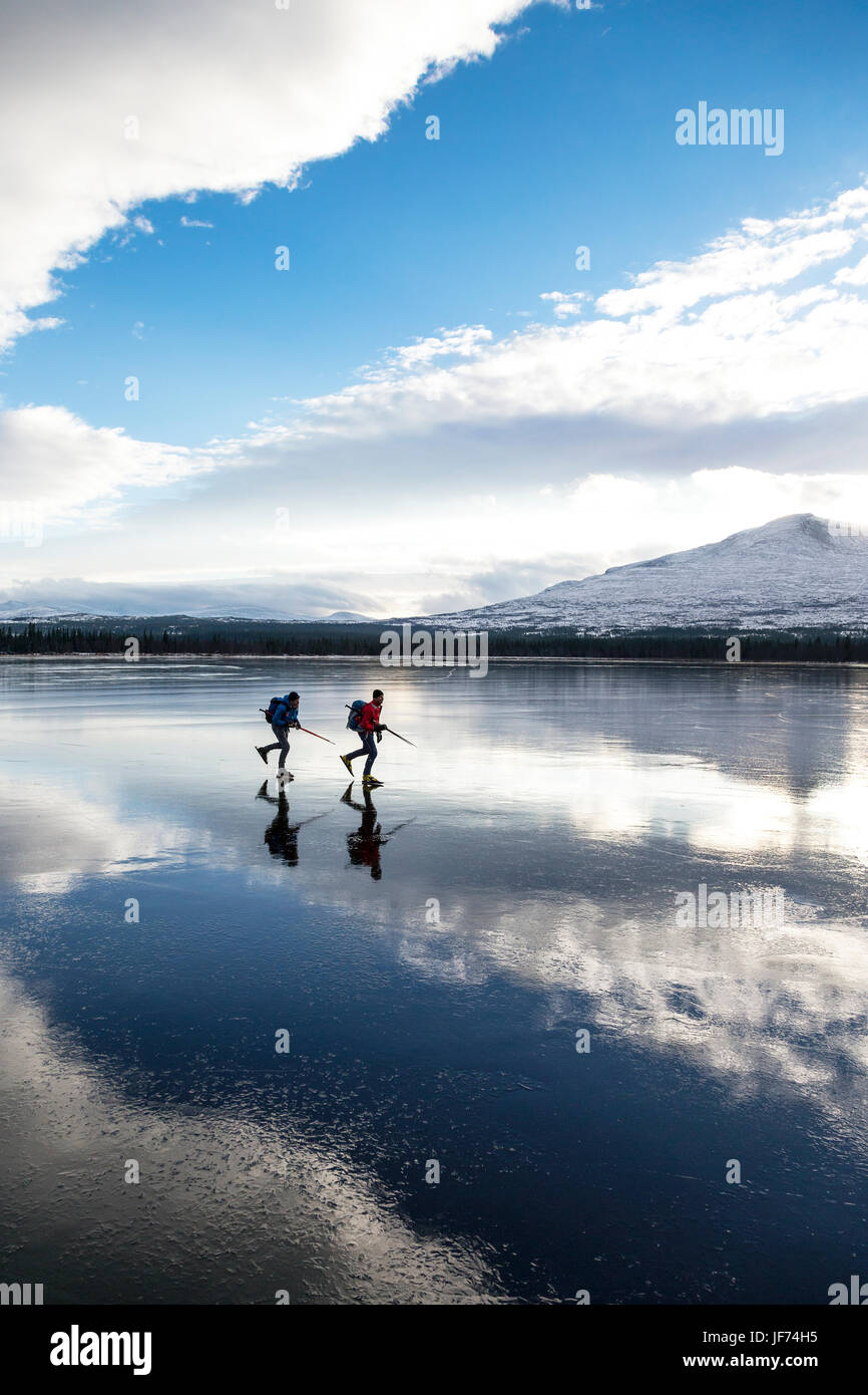 Two people moving on ice Stock Photo - Alamy