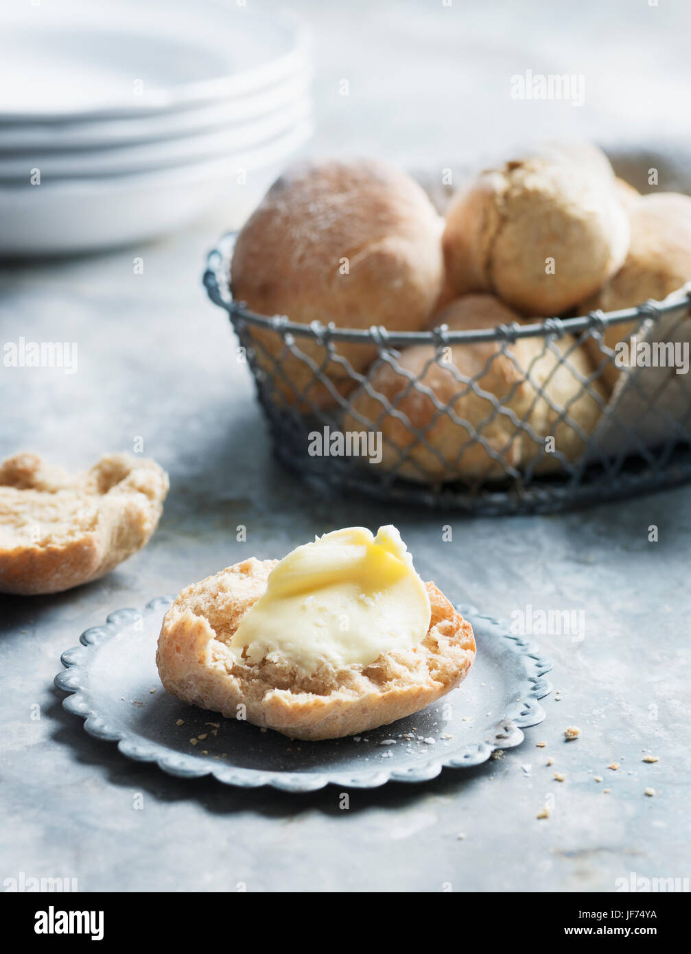 Bun with butter on table Stock Photo - Alamy