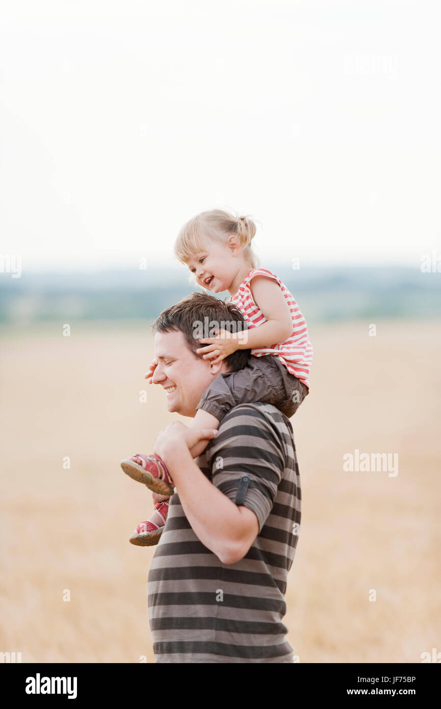 Father carrying daughter in field Stock Photo - Alamy