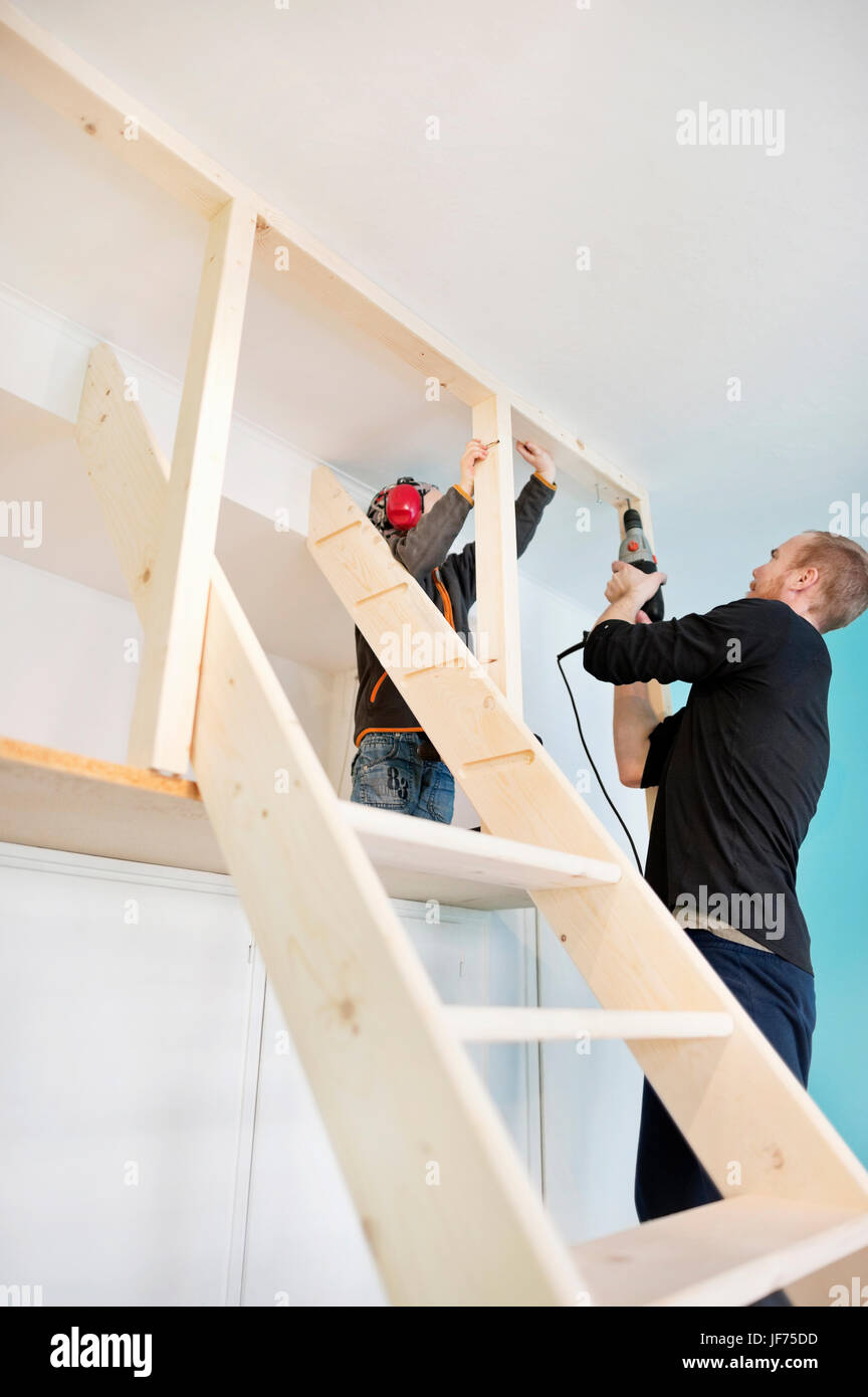 Father and daughter using drill at home Stock Photo - Alamy