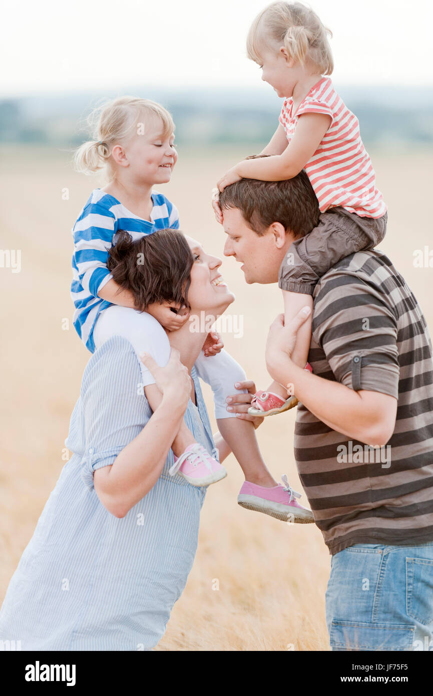Family with two children in field Stock Photo - Alamy