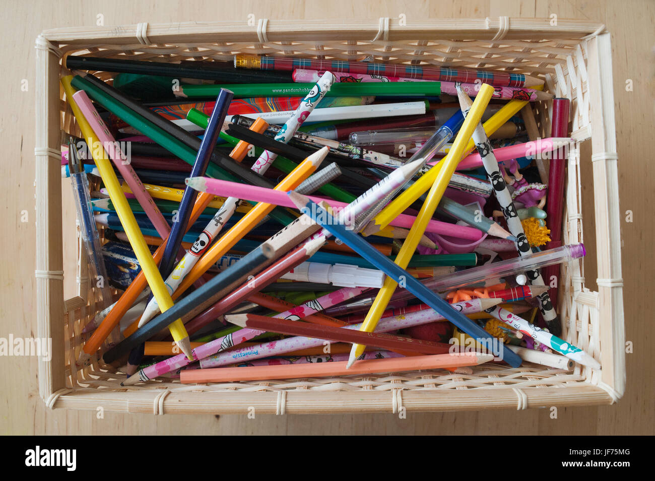 Pencils and pens in basket Stock Photo - Alamy