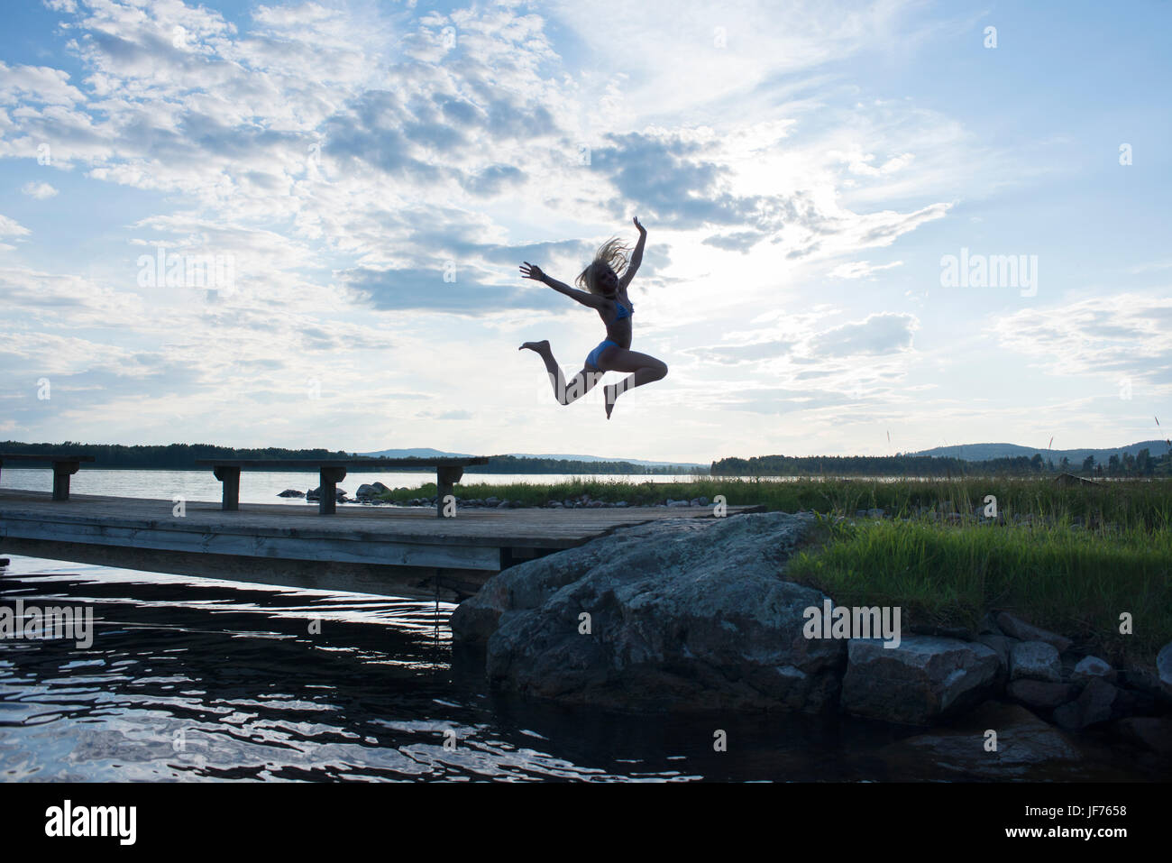 Jumping into lake girl hi-res stock photography and images - Alamy