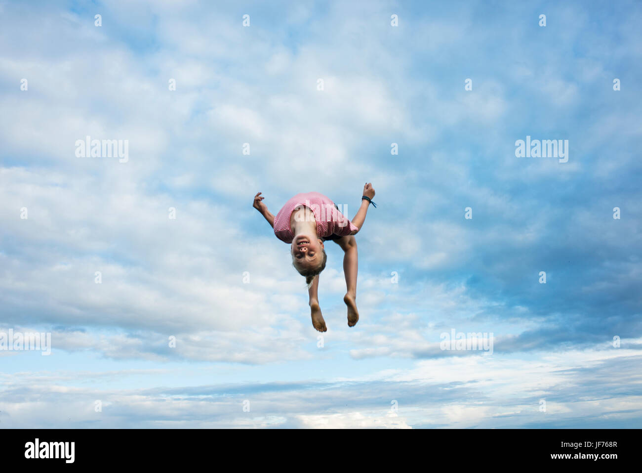 Girl Doing Somersault Mid air Stock Photo Alamy