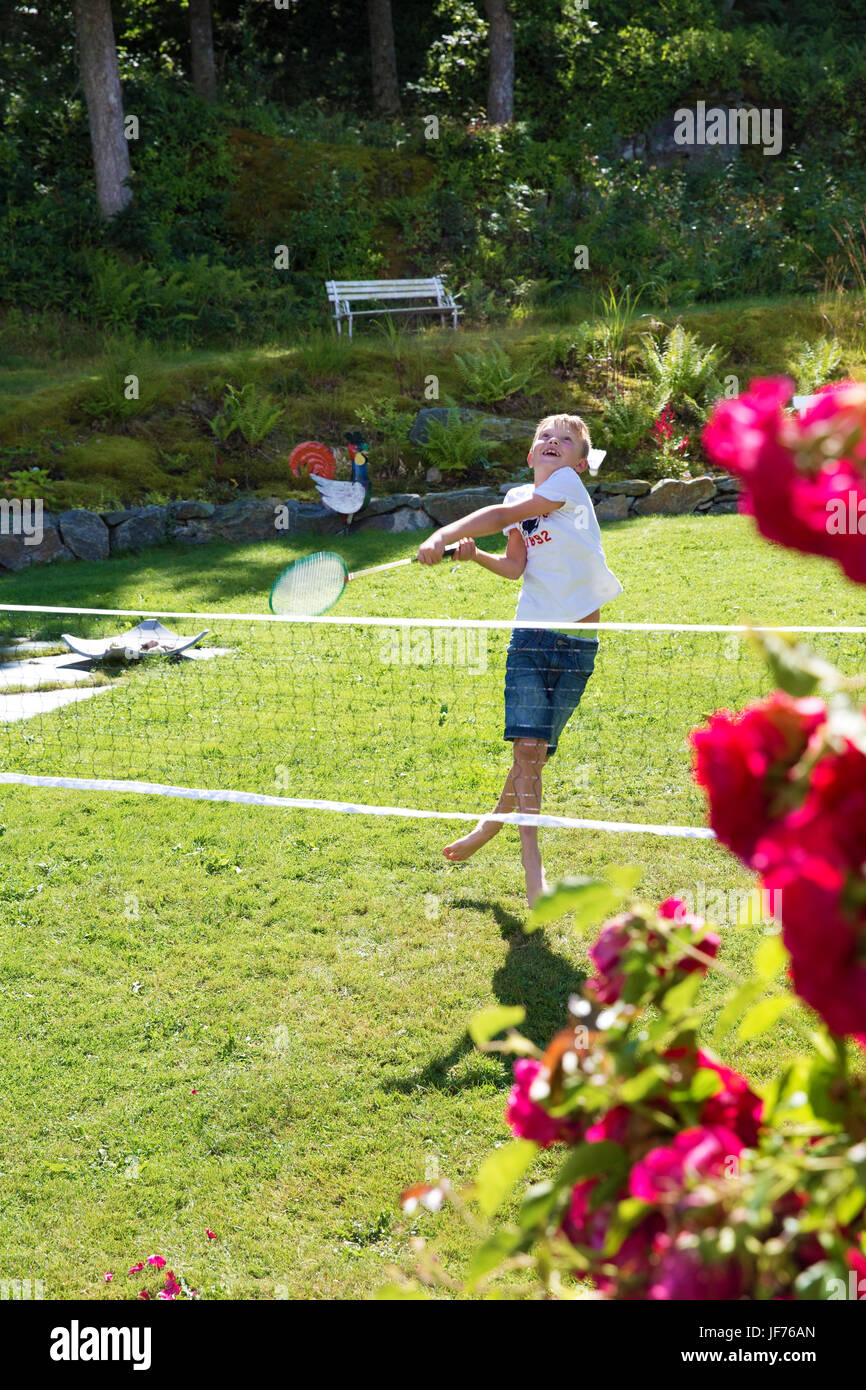 Boy playing badminton in garden Stock Photo - Alamy
