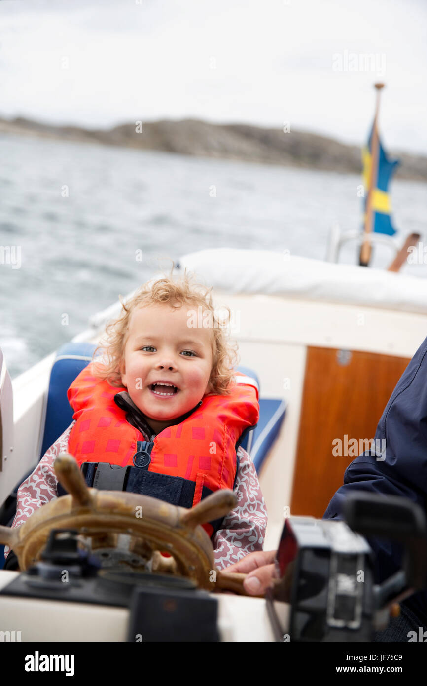 Cute girl driving boat hi-res stock photography and images - Alamy