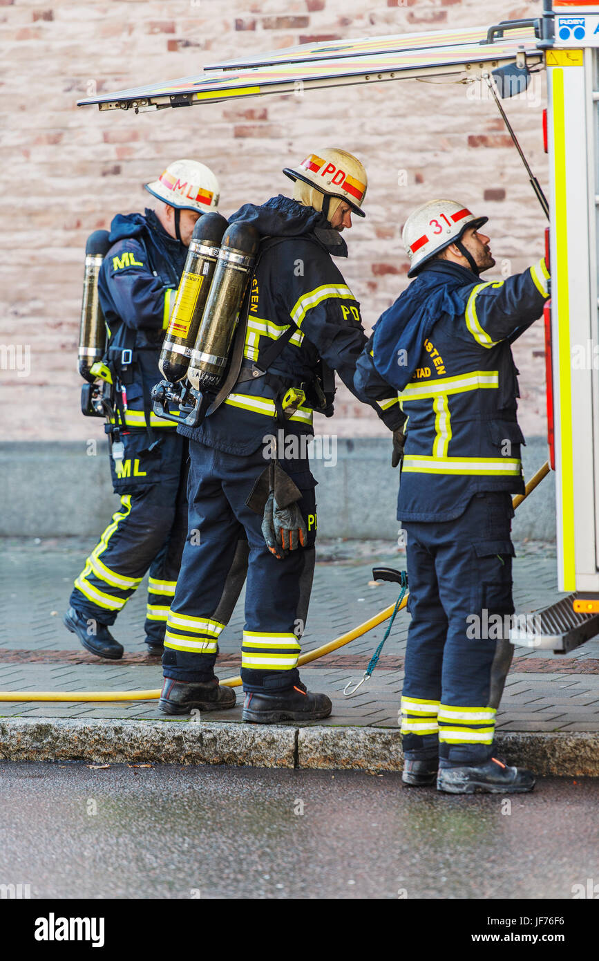 Firefighters by fire engine Stock Photo - Alamy