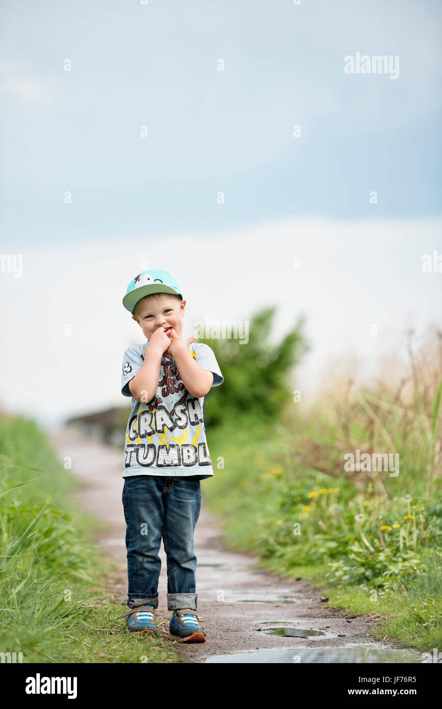 Boy standing on footpath Stock Photo - Alamy