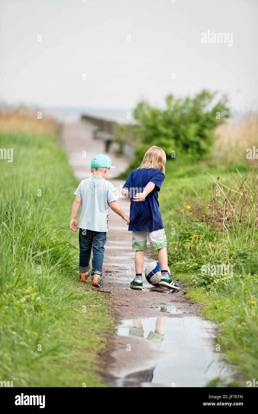 Boys walking together Stock Photo - Alamy