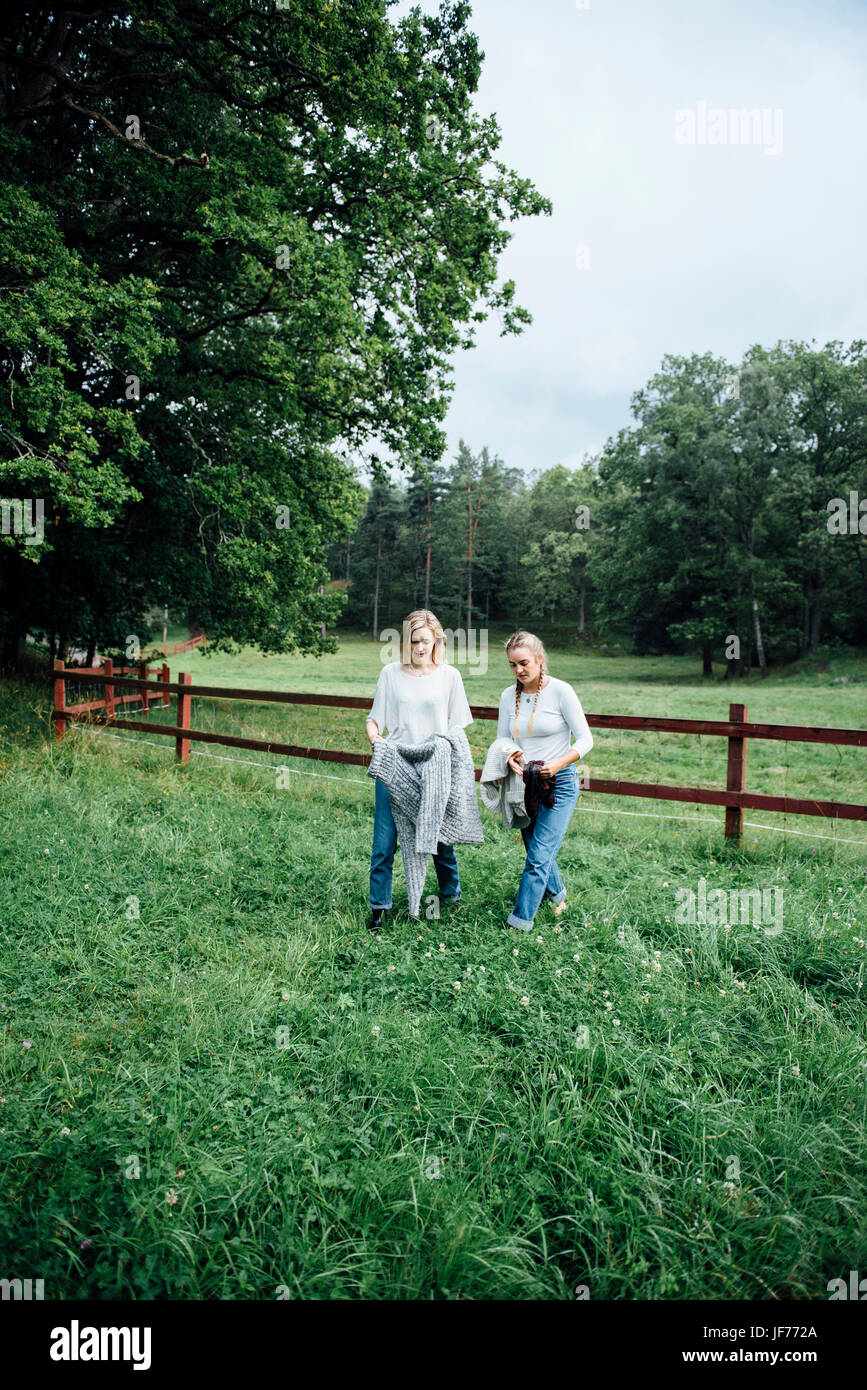 Two women at a fence Stock Photo - Alamy