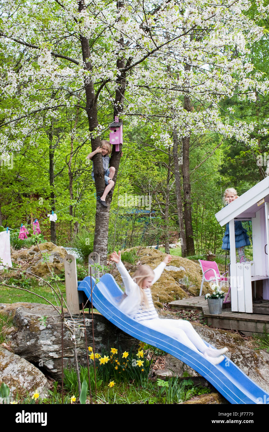 Three girls playing in front or back yard Stock Photo - Alamy