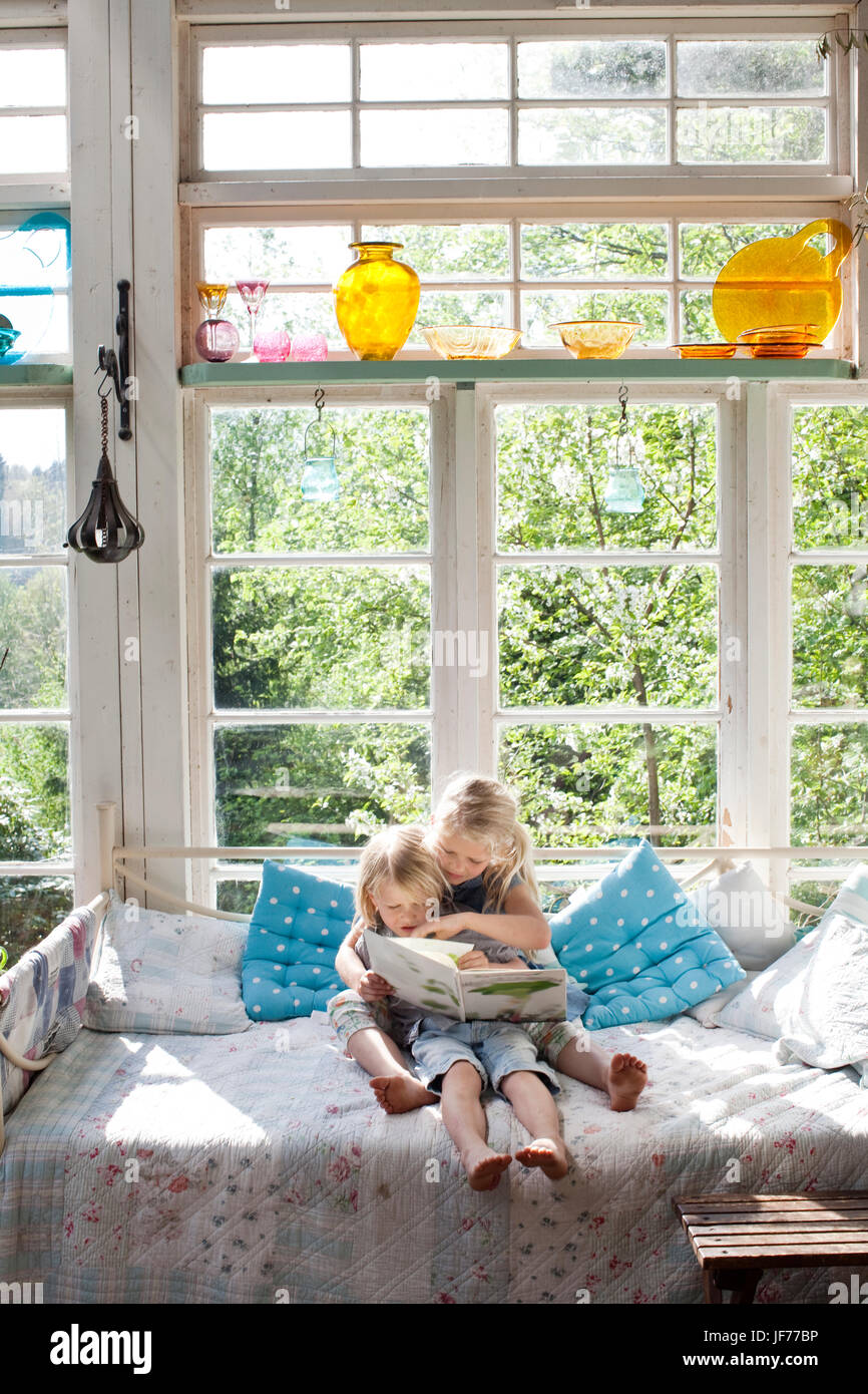 Two girls reading book hi-res stock photography and images - Alamy