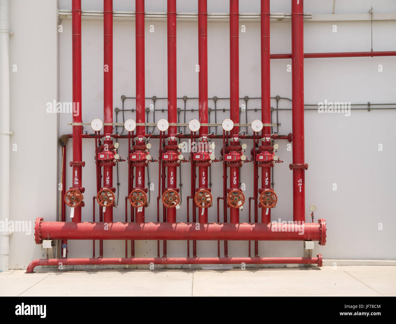 A row of red color fire fighting water supply pipeline system Stock ...