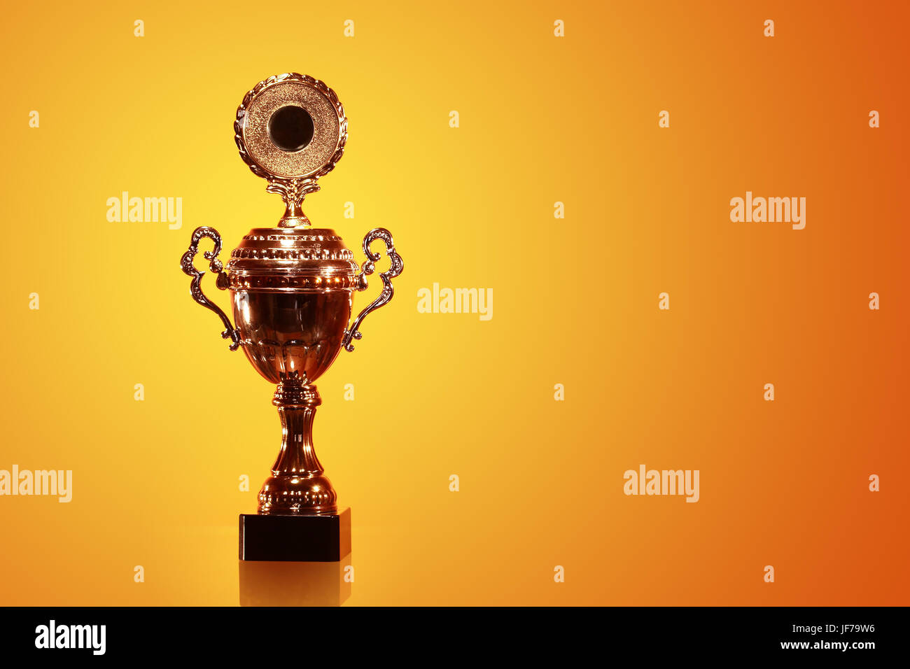 High gold trophy on orange background with free space for text Stock ...